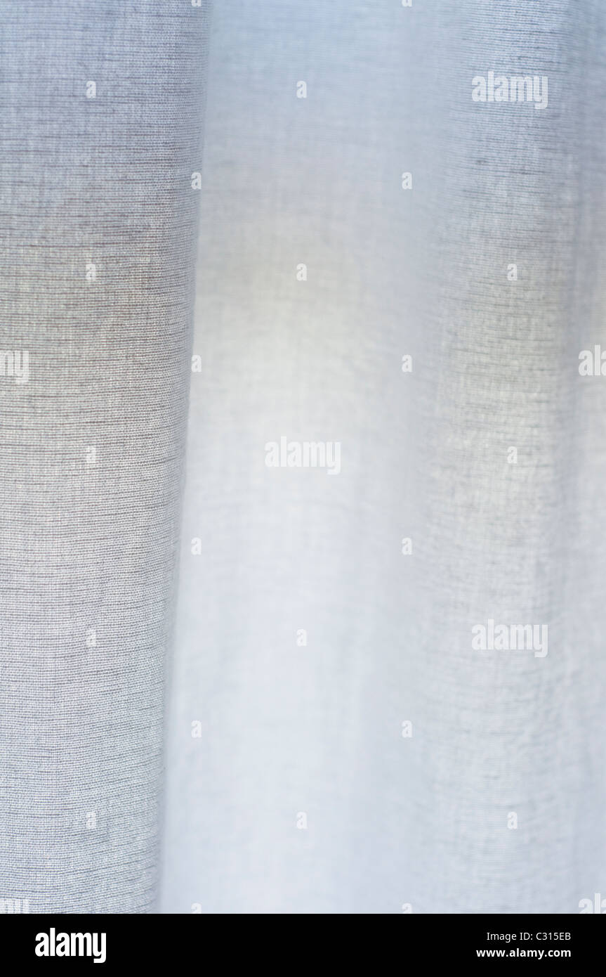 White cotton curtains with daylight filtering through on a Spring day ...