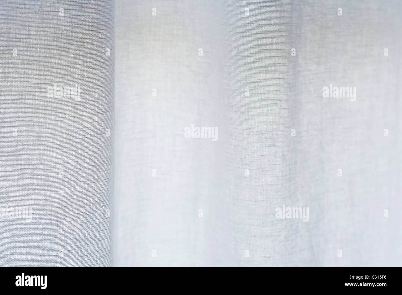 White cotton curtains with daylight filtering through on a Spring day ...