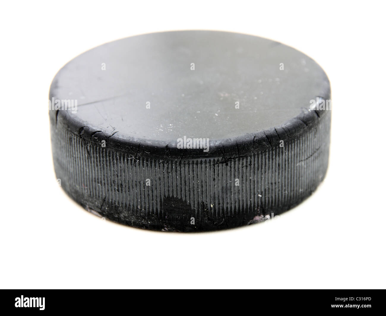 Black old hockey puck isolated on white background Stock Photo - Alamy