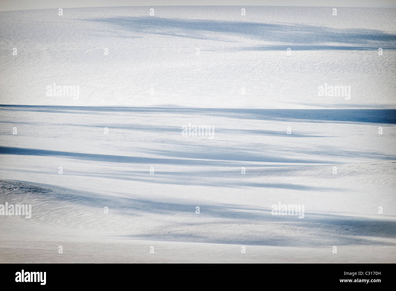 Snow field in Antarctica with streaks of shadows Stock Photo - Alamy