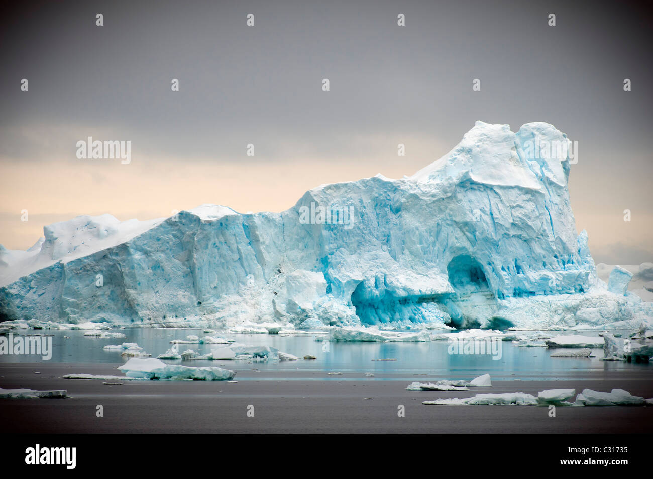 Giant, floating iceberg in Antarctica with ice cave Stock Photo - Alamy