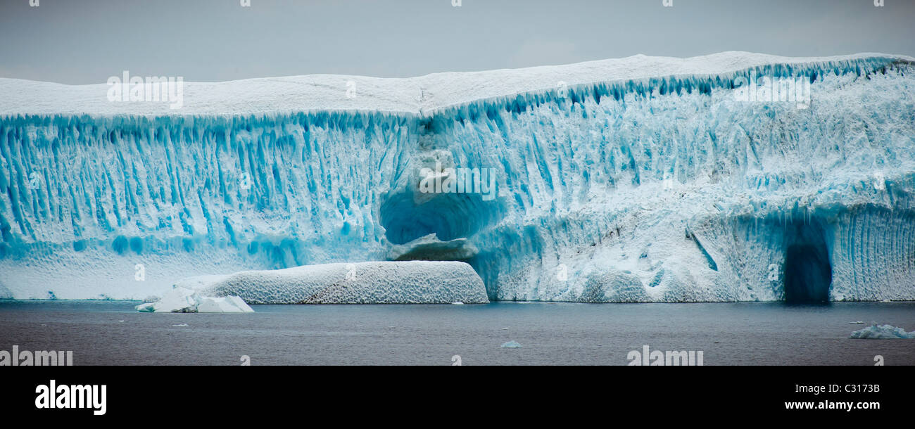 Large iceberg floating in ocean in Antarctica with ice cave Stock Photo ...