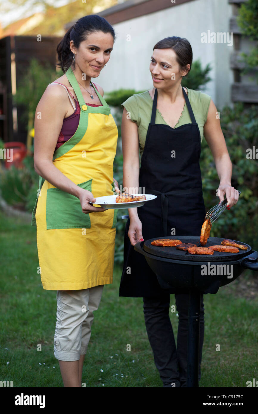 Barbecue women in the garden having fun Stock Photo - Alamy