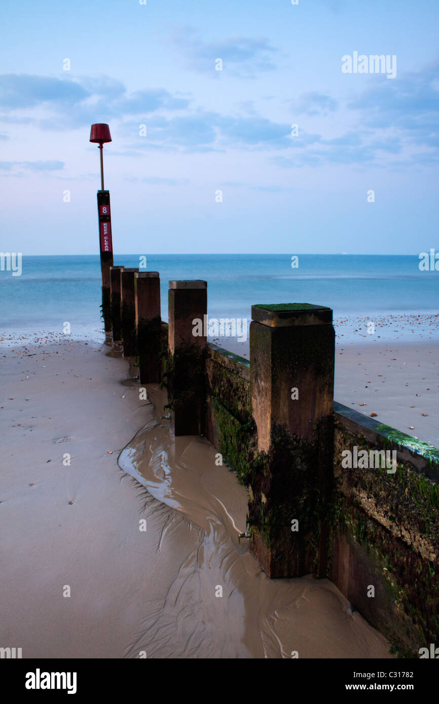 A beach groyne, seen at low tide. These sea defences stop the sand ...