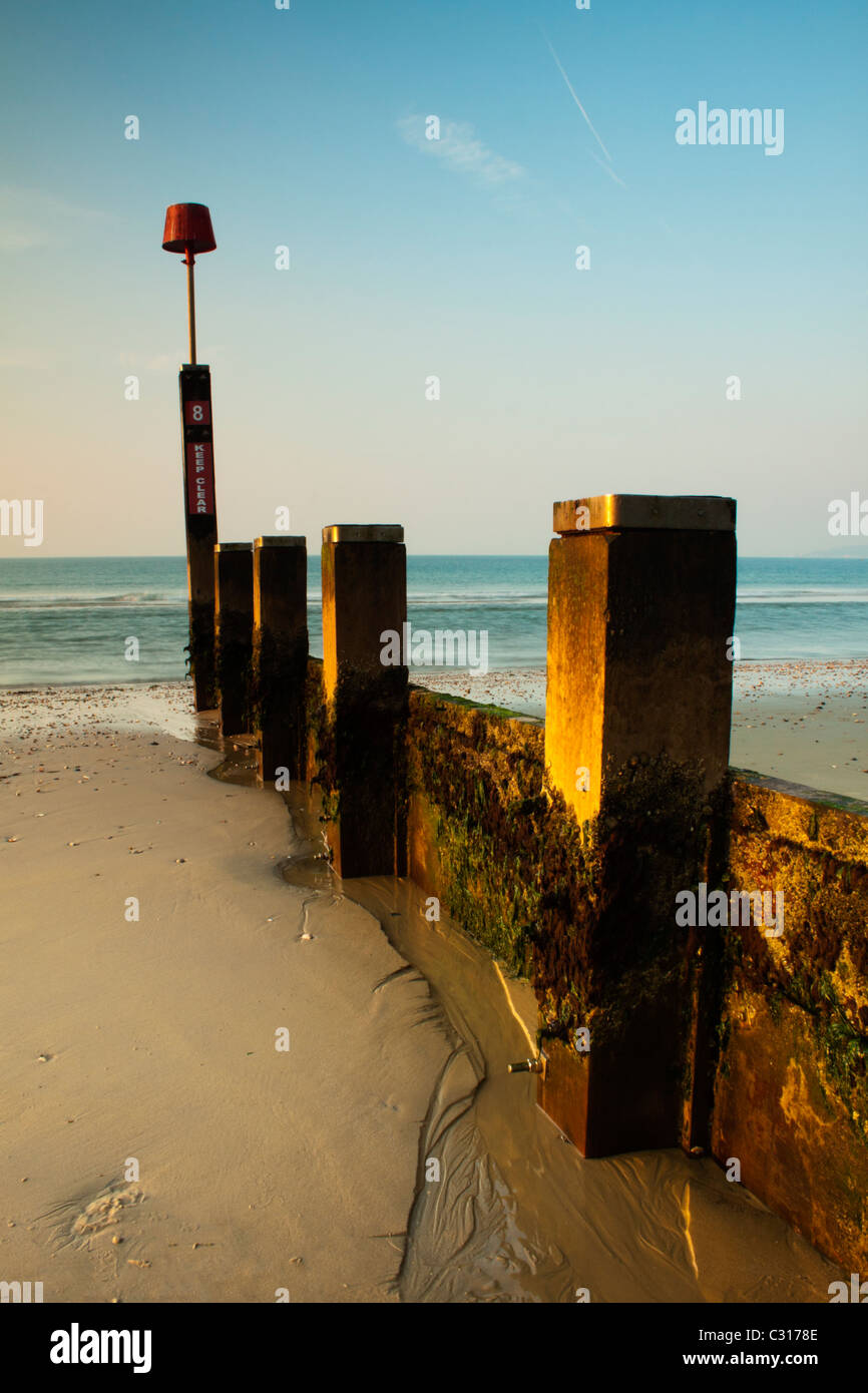 A beach groyne, seen at low tide. These sea defences stop the sand ...