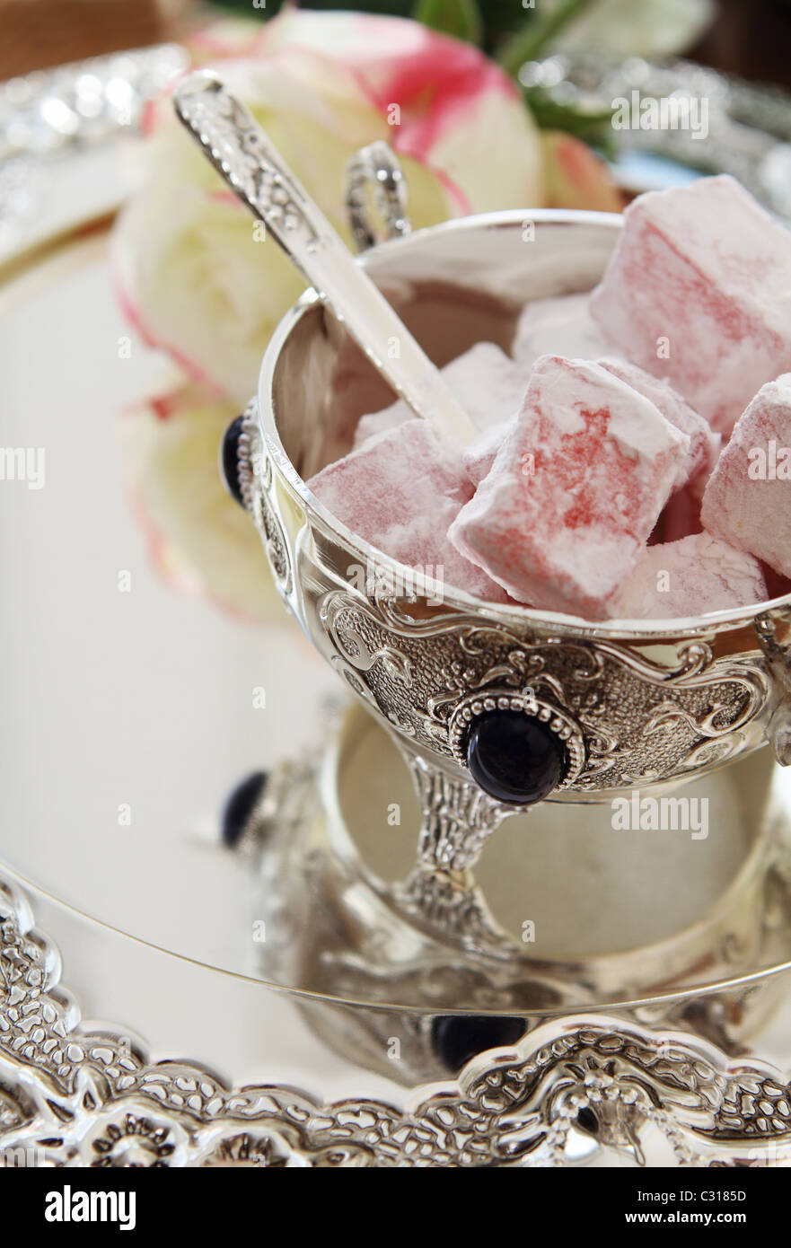 East sweets in silver ware with rose Stock Photo - Alamy