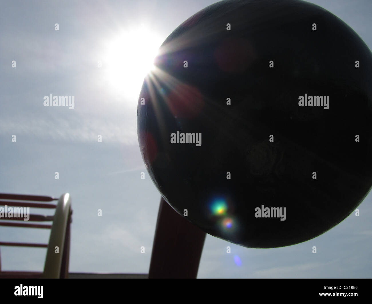 A playground object with the sun behind it Stock Photo - Alamy