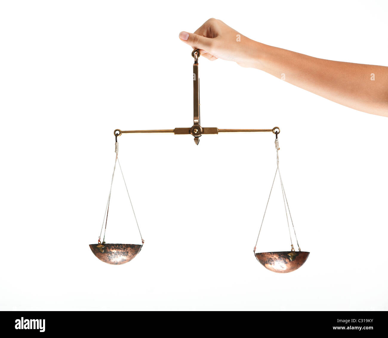 Hand of judge holding scales in isolation Stock Photo - Alamy