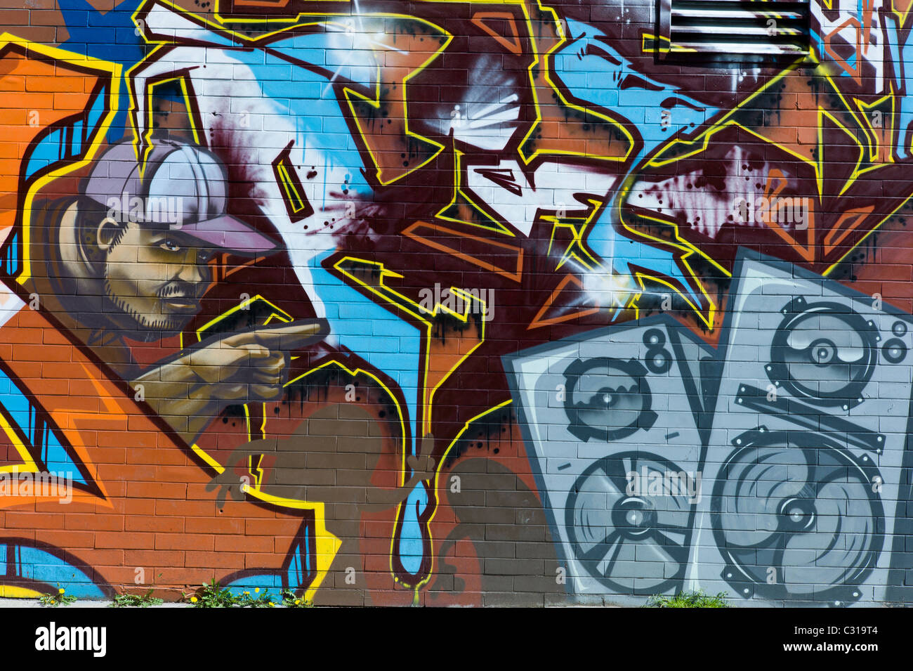 Artful graffiti on a long brick wall in Munich-Giesing showing a ...