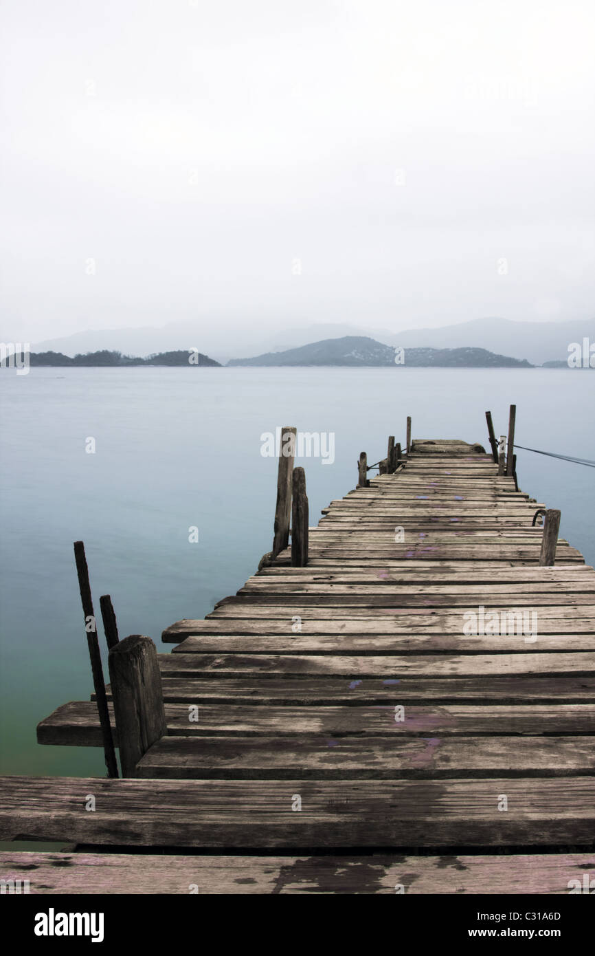 Looking over a desolate peer and a boat Stock Photo - Alamy