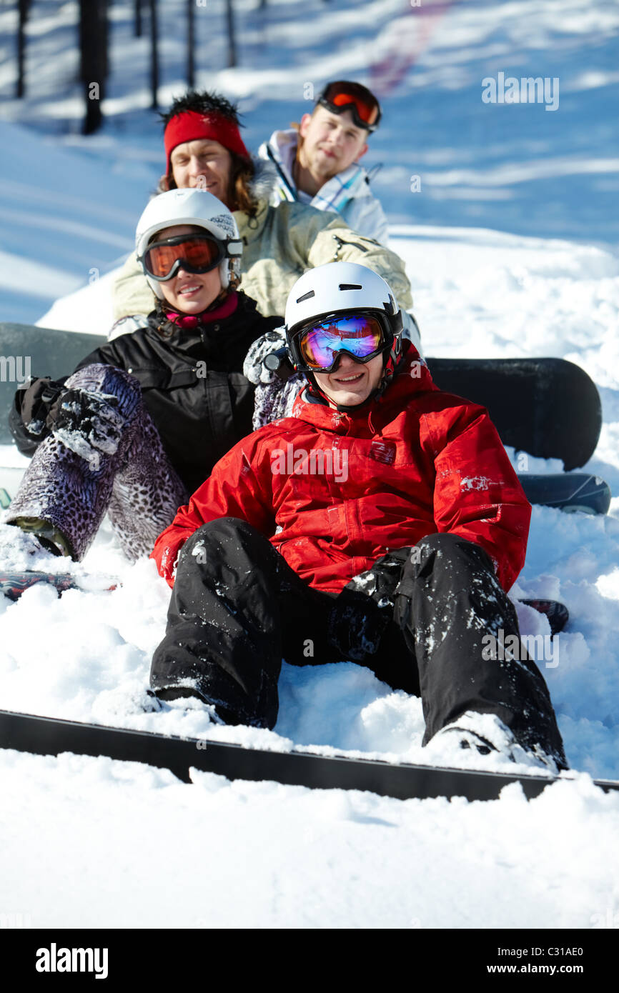 Portrait of happy friends snowboarding during winter vacations Stock ...