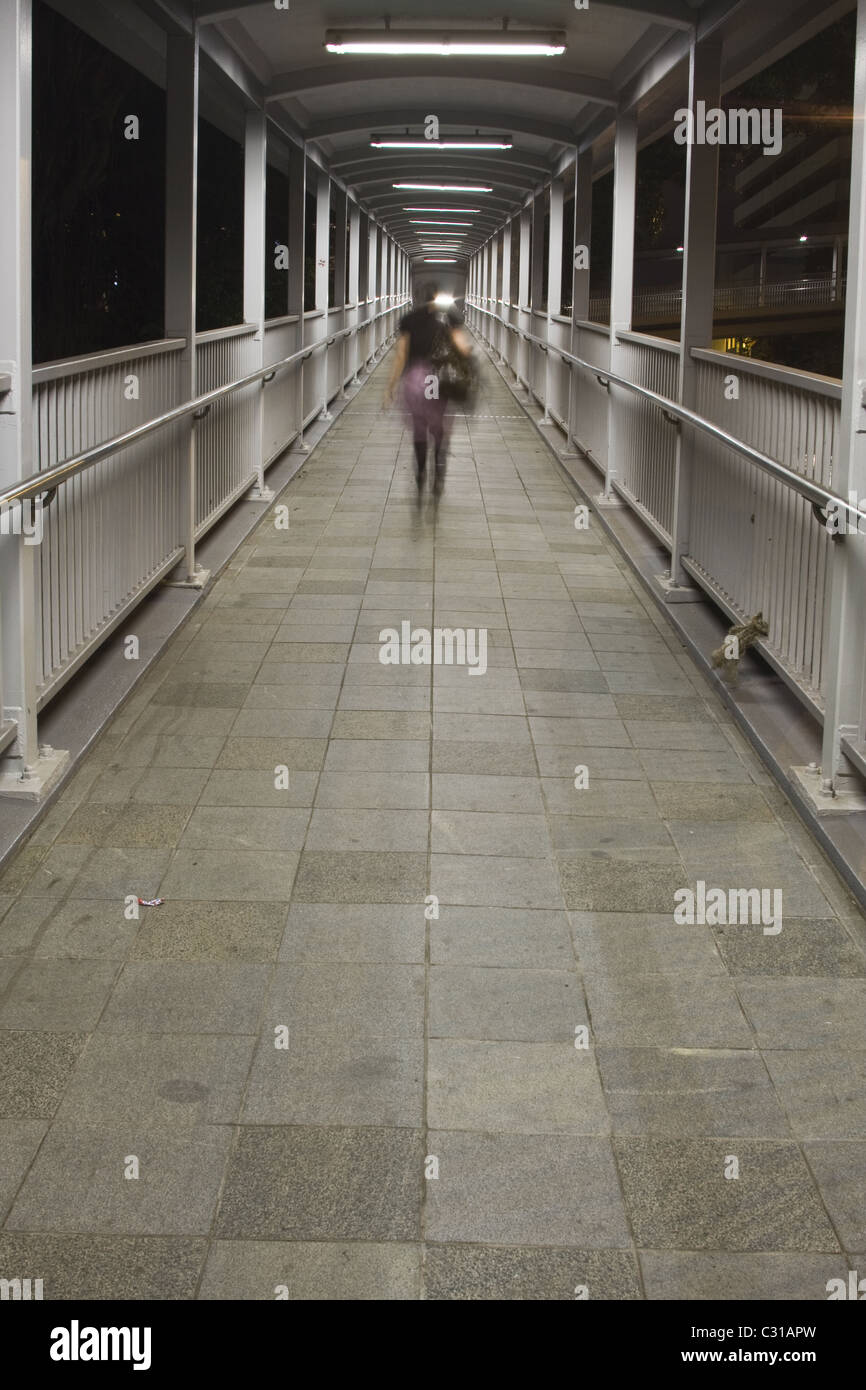 a woman walking on flyover to go home at night Stock Photo - Alamy
