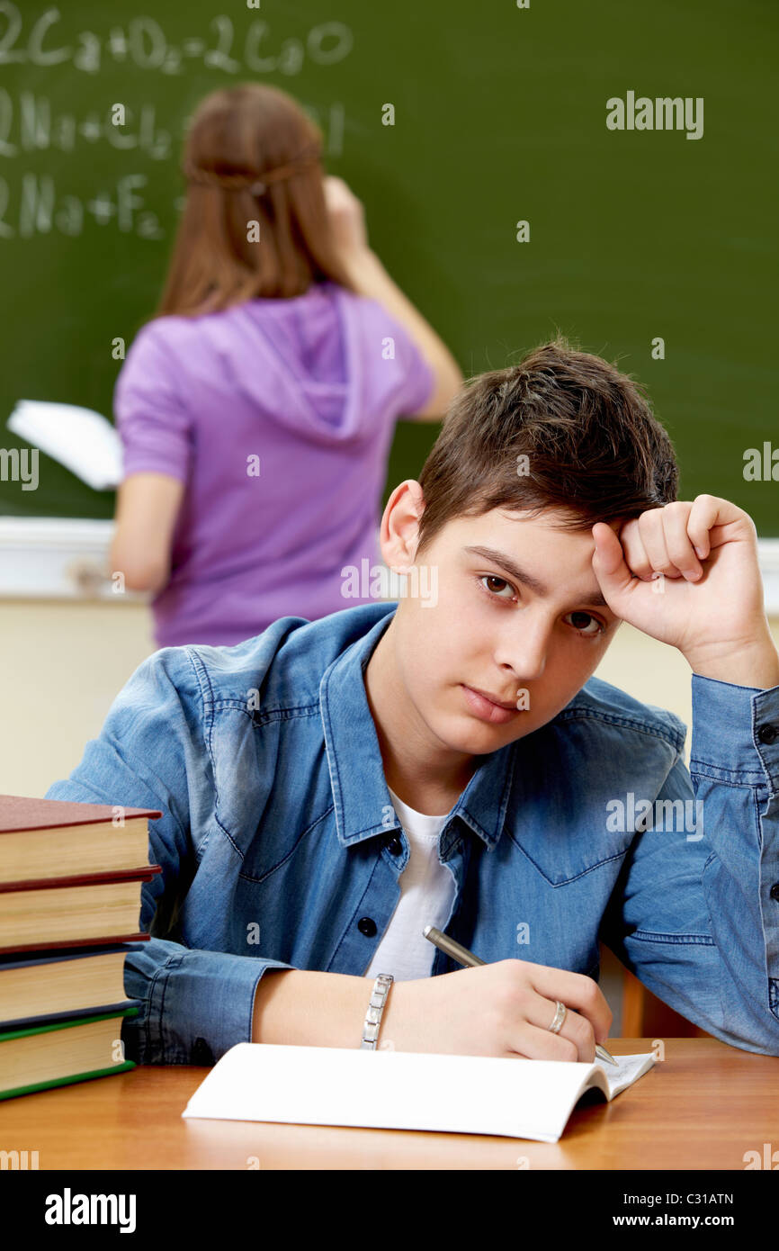 Portrait of smart guy looking at camera in working environment Stock ...