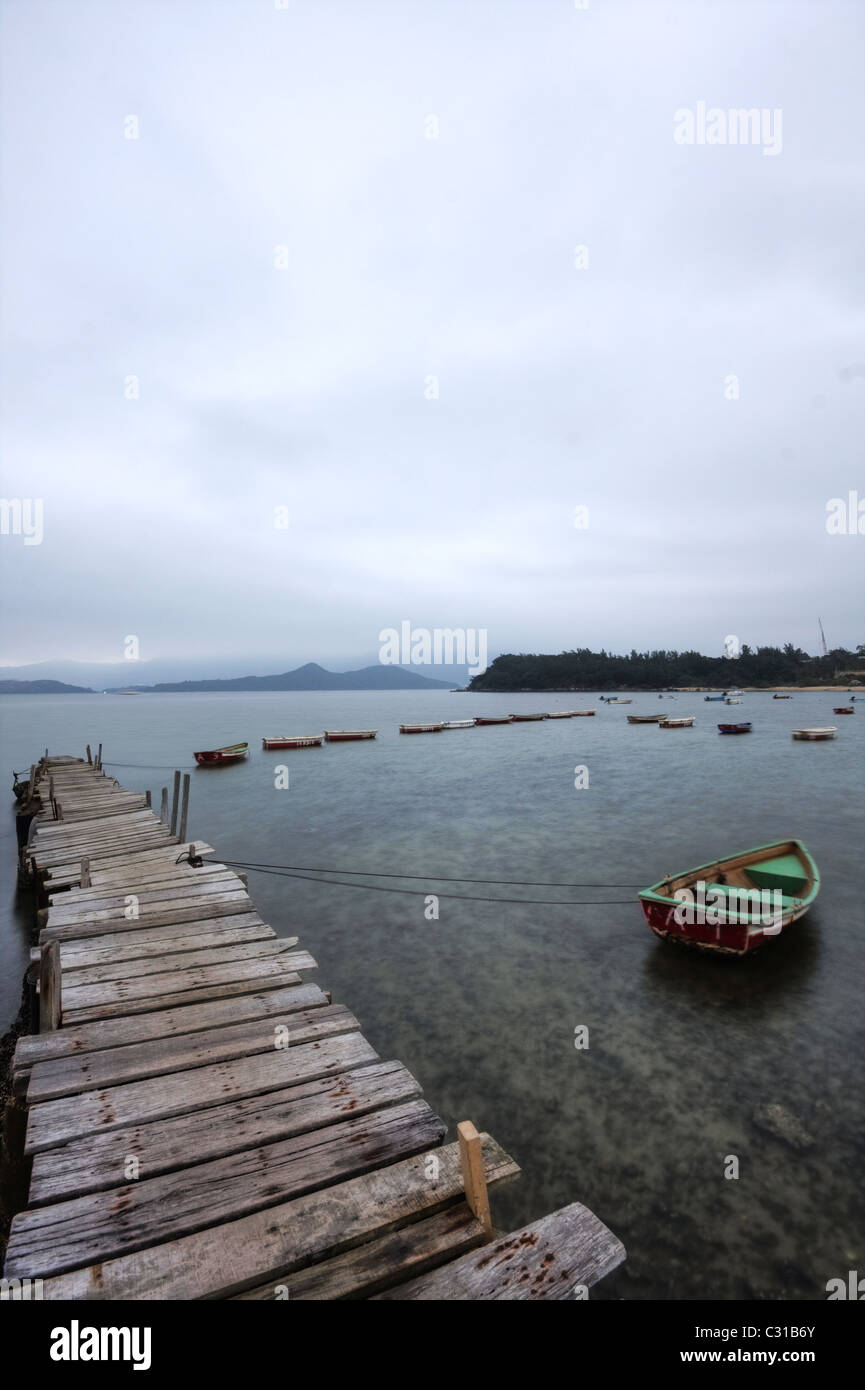 Looking over a desolate peer and a boat Stock Photo - Alamy