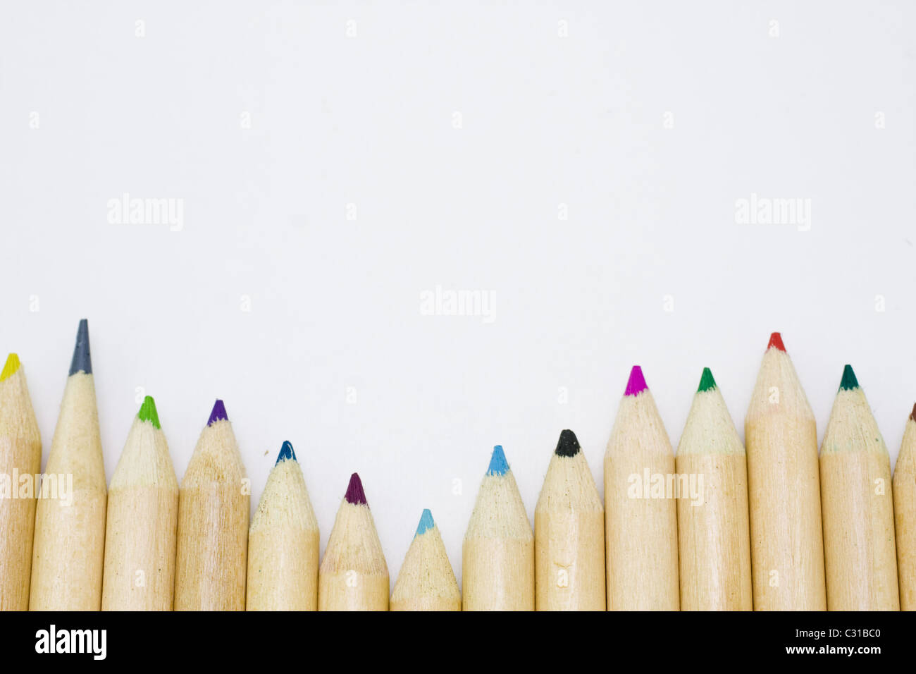 Colored pencils forming a color row. White background Stock Photo - Alamy