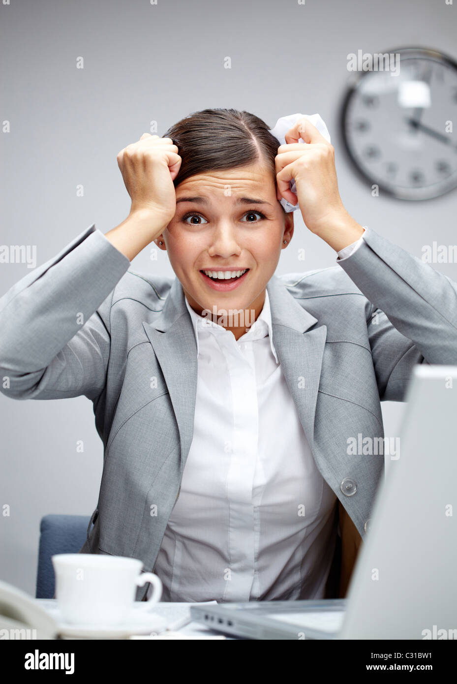 Image of shocked employer touching her head at workplace Stock Photo ...