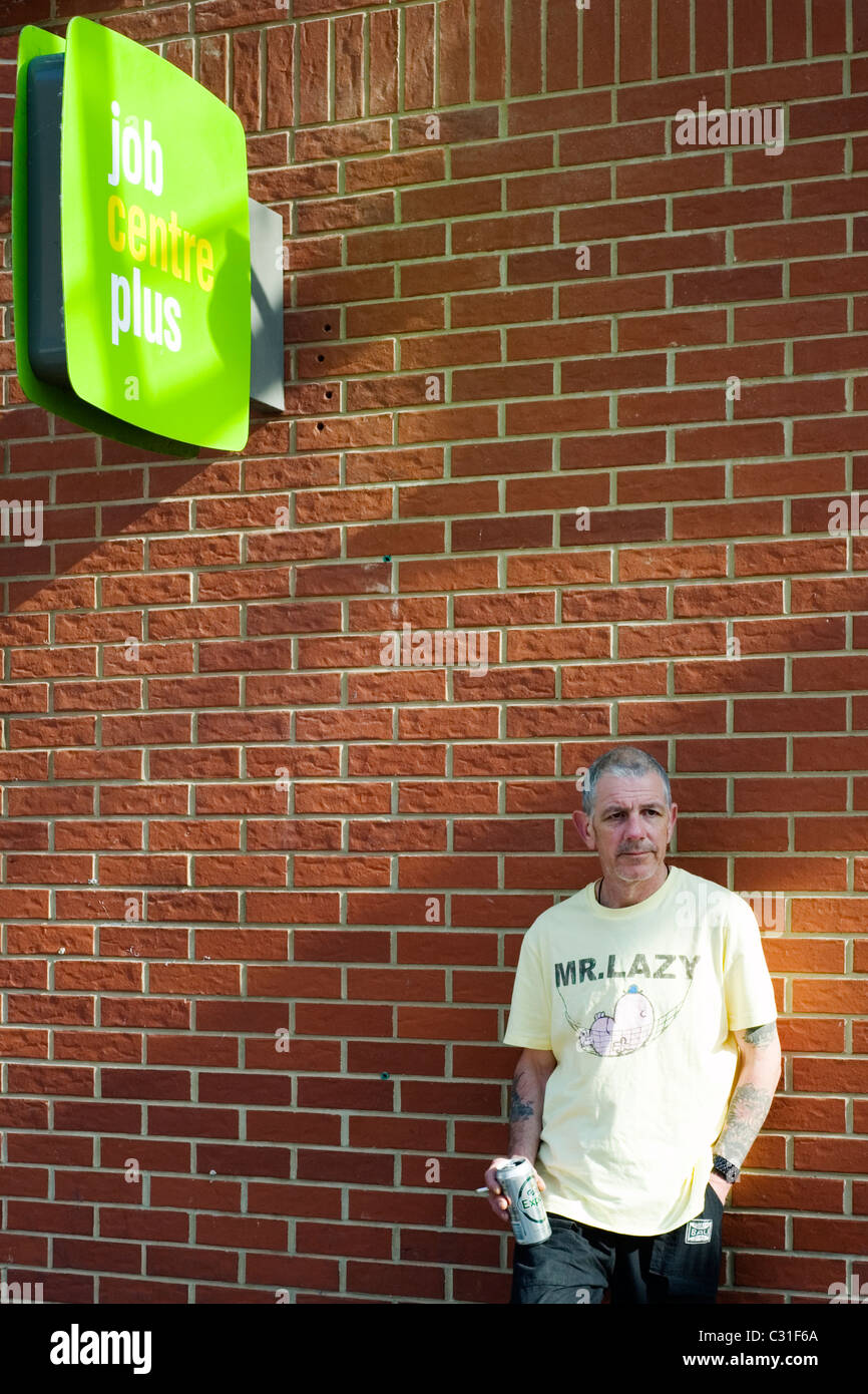man drinking beer and smoking outside of job center Stock Photo - Alamy