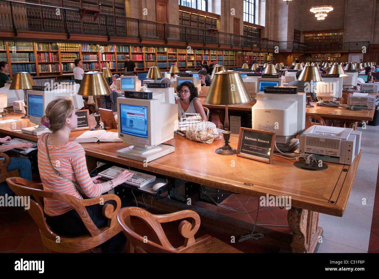 STUDENTS STUDYING IN THE READING ROOM OF THE NEW YORK PUBLIC LIBRARY ...