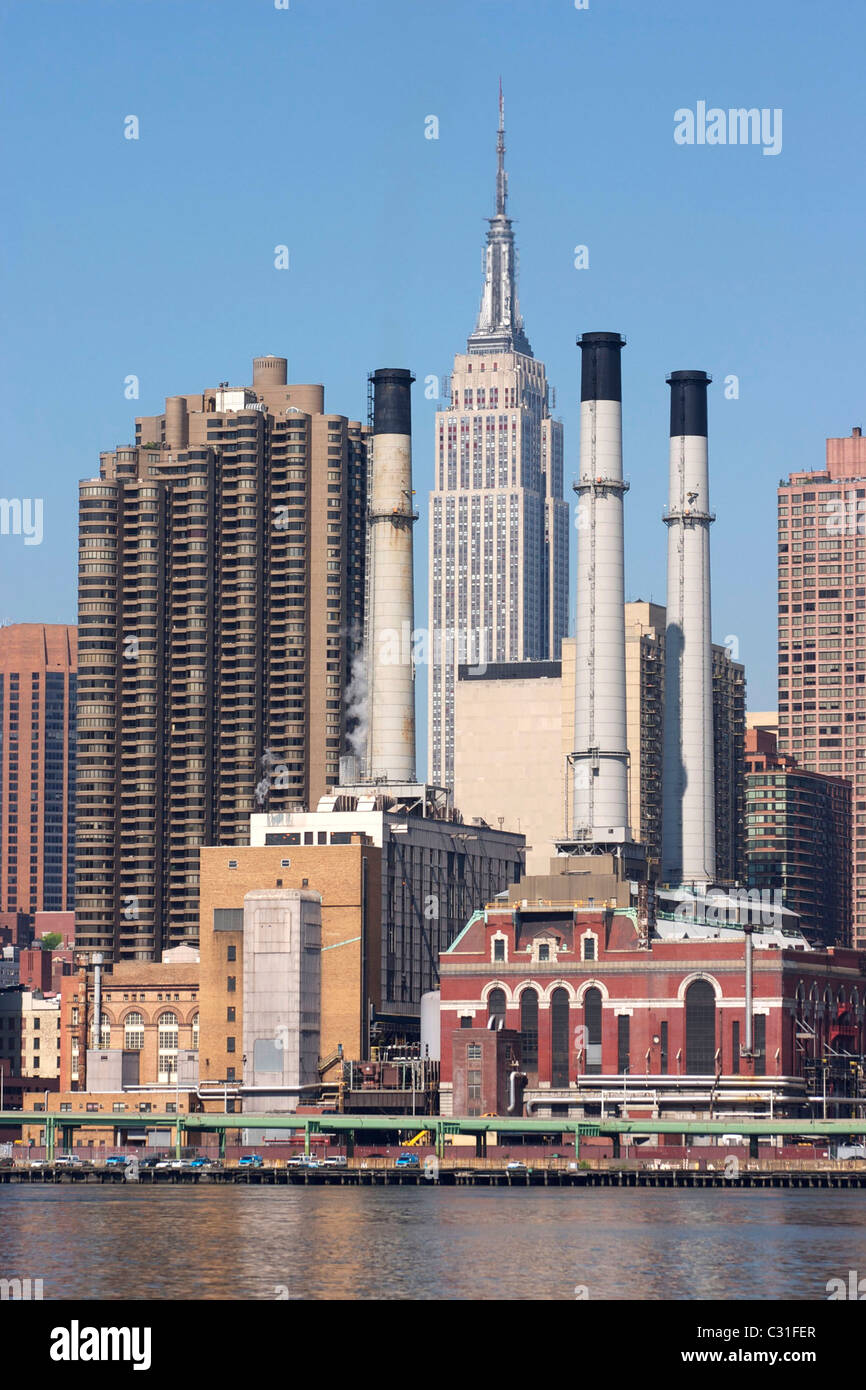 THE EMPIRE STATE BUILDING APPEARING BETWEEN TWO BUILDINGS AND A POWER ...