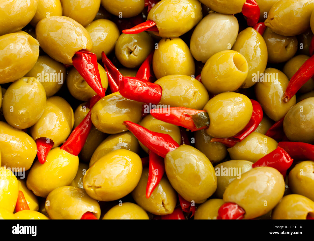 lots of Green olives stuffed with red chilli Stock Photo - Alamy