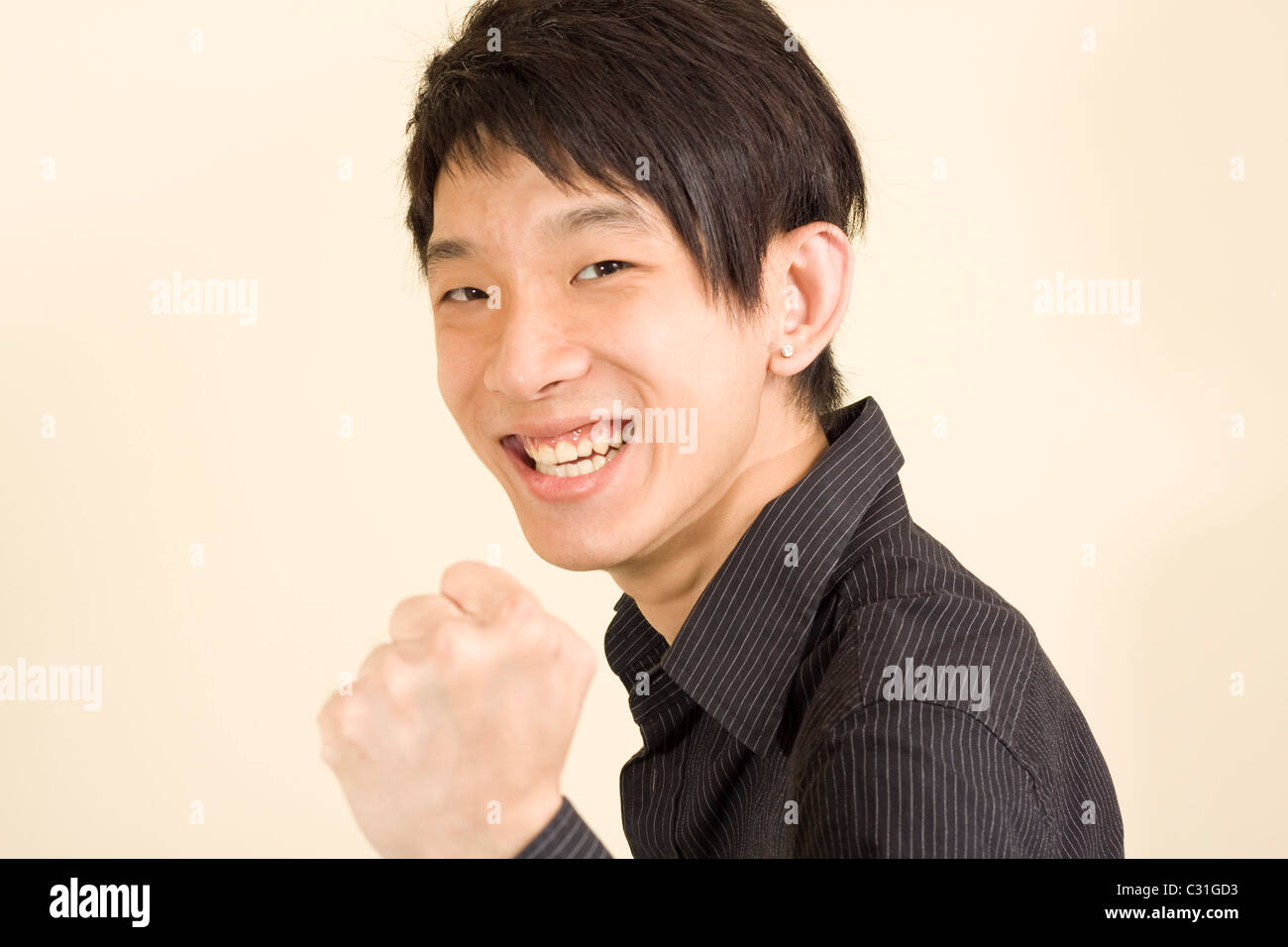 Young Asian man making fight Stock Photo - Alamy