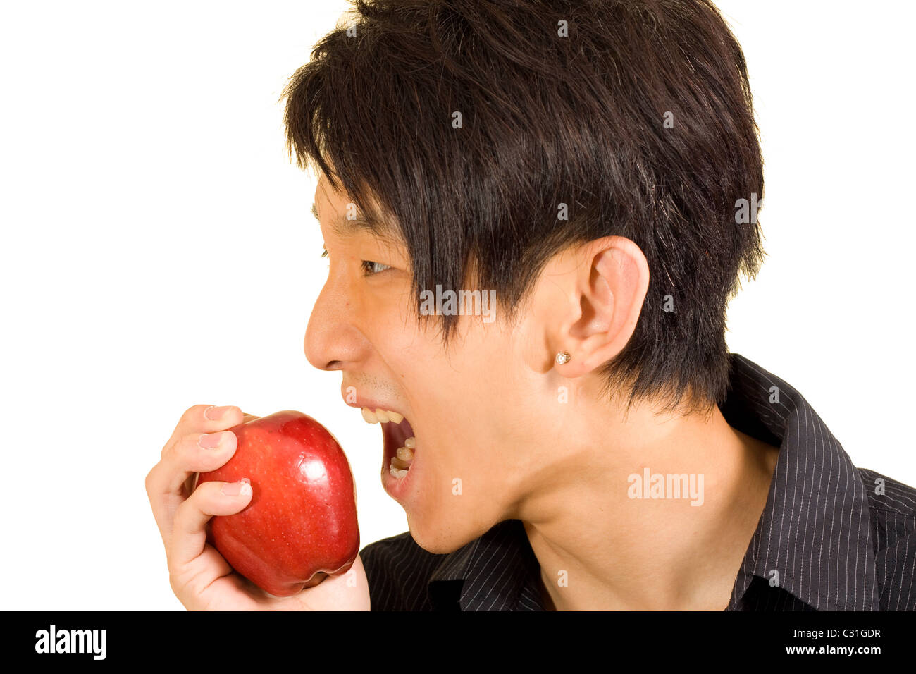 Young Asian man eating apple Stock Photo - Alamy