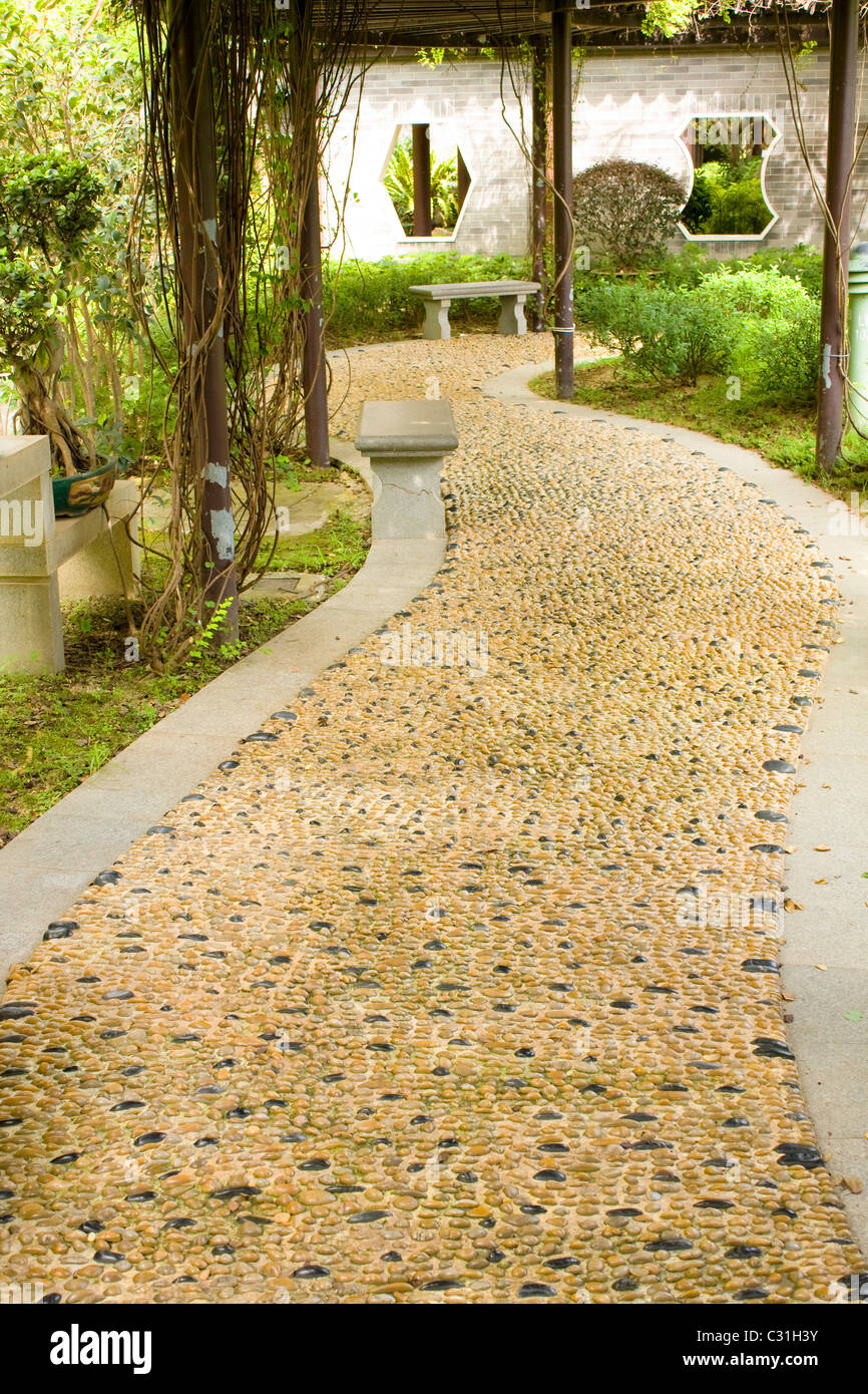 Stone walkway winding in garden Stock Photo - Alamy