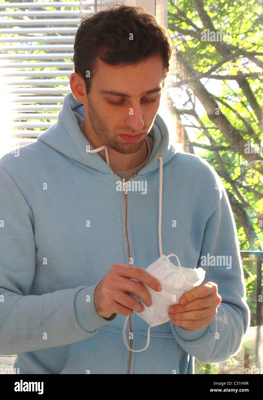YOUNG MAN WEARING A SURGICAL MASK, PREVENTION AND FIGHT AGAINST THE ...
