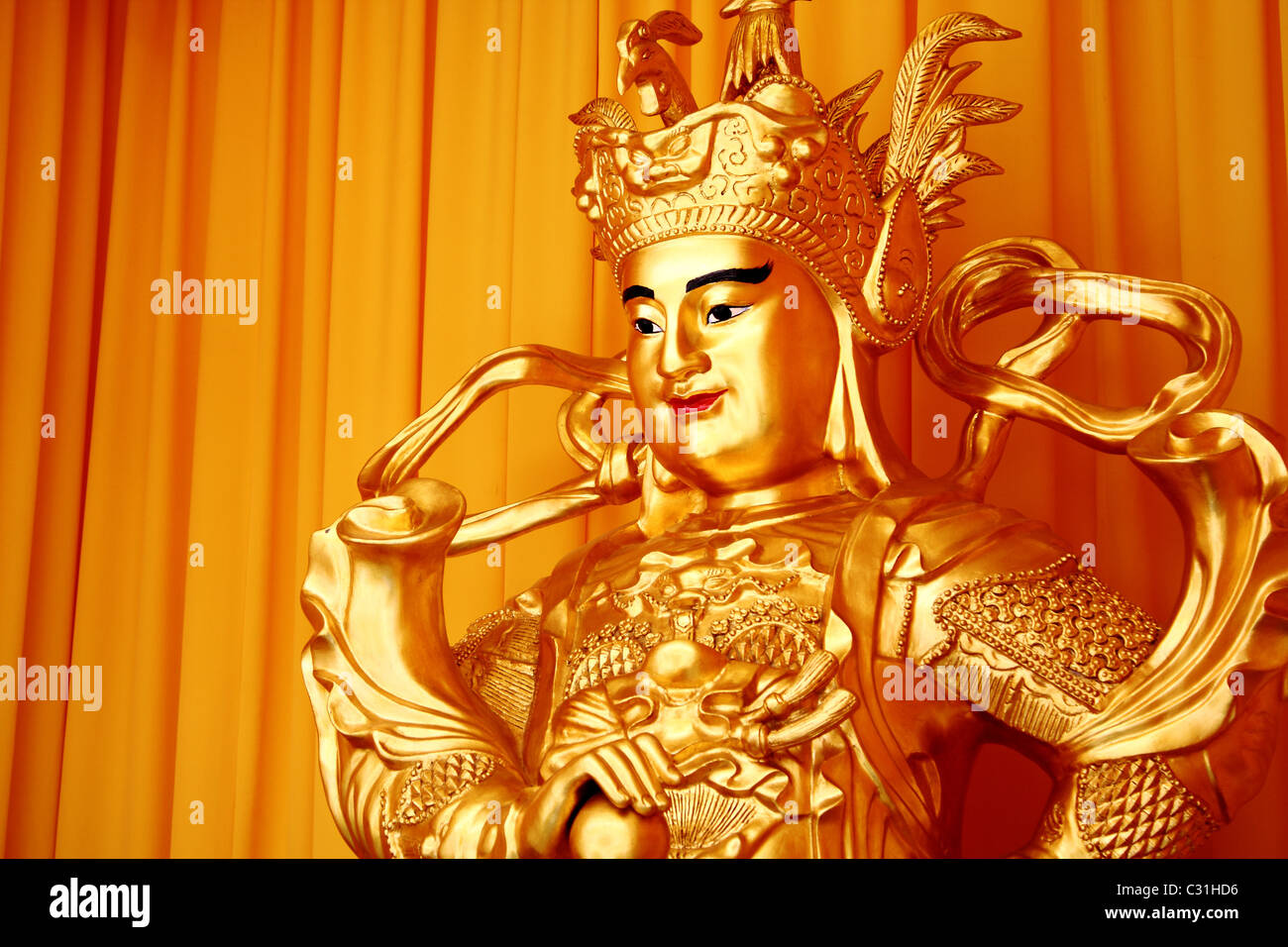 tradition chinese male buddha with gold toned Stock Photo - Alamy