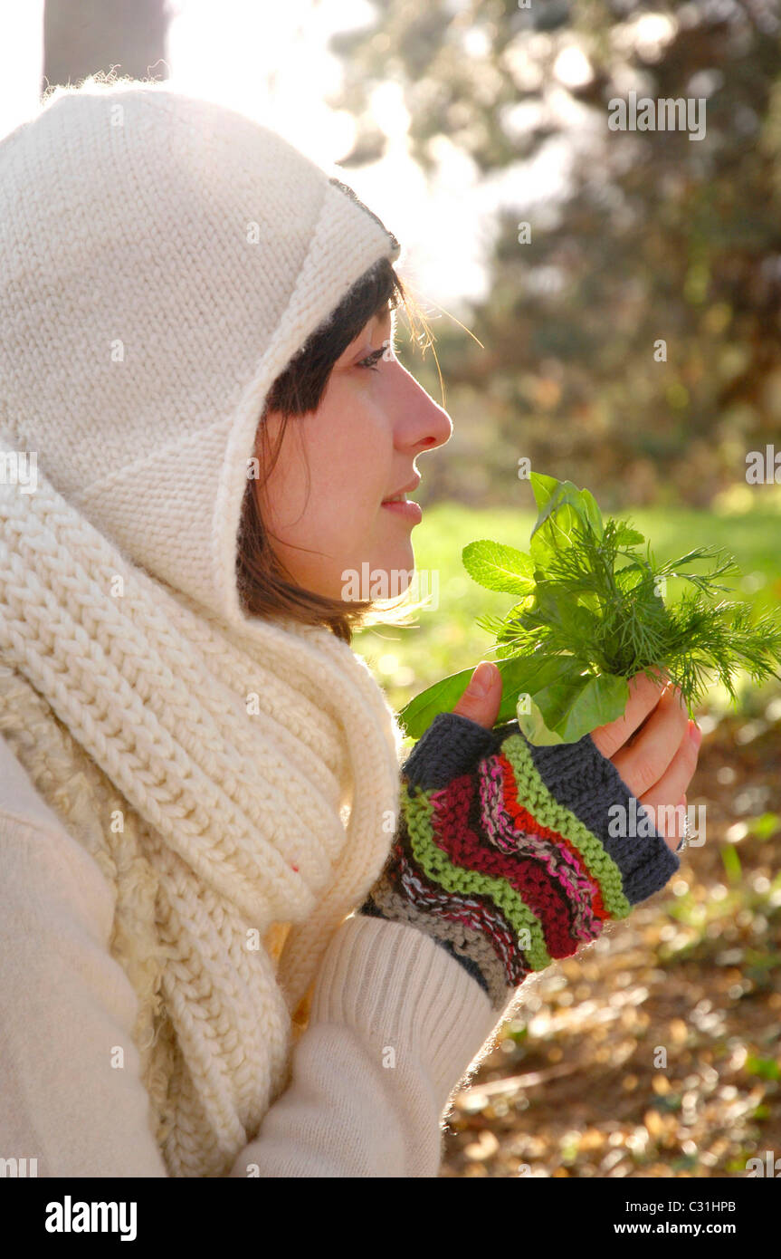 HEALTH AND PLANTS. YOUNG WOMAN IN THE OUTDOORS WITH A BUNCH OF HERBS ...