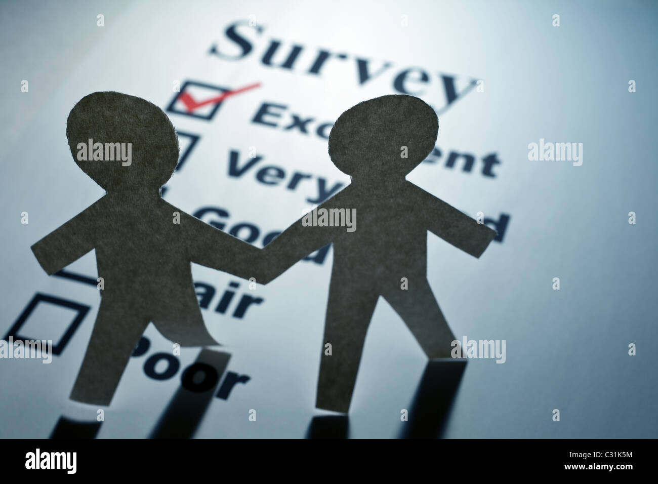 survey and Paper Chain Men close up Stock Photo - Alamy