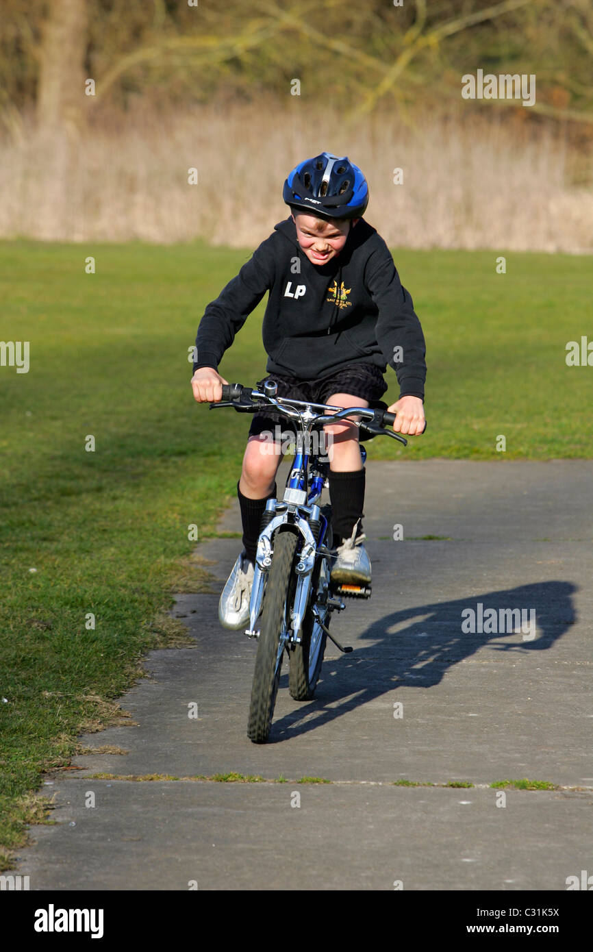 Boy riding bicycle Stock Photo - Alamy