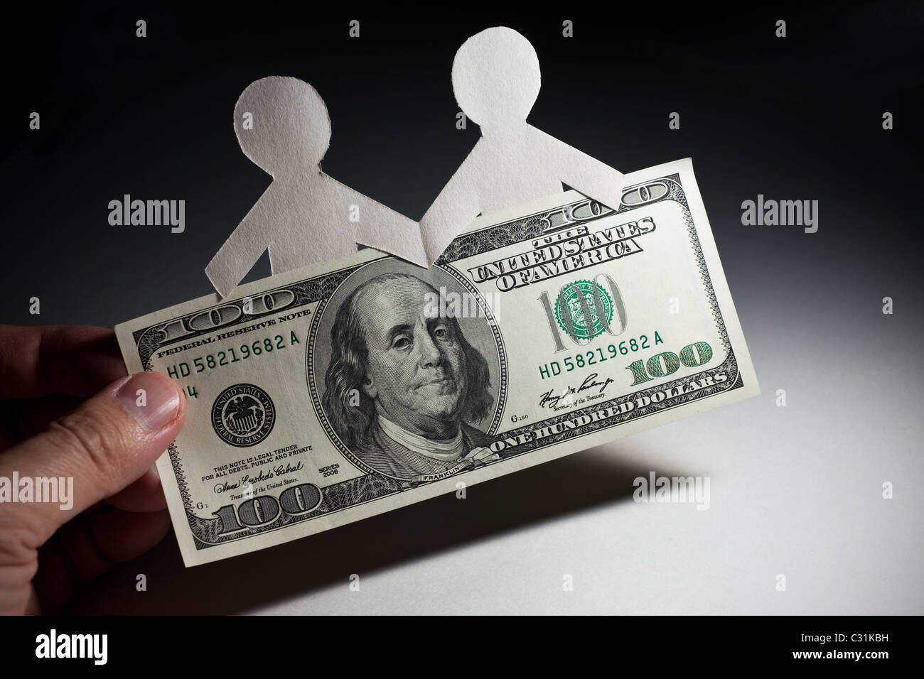 Dollar and Paper Chain Men close up Stock Photo - Alamy