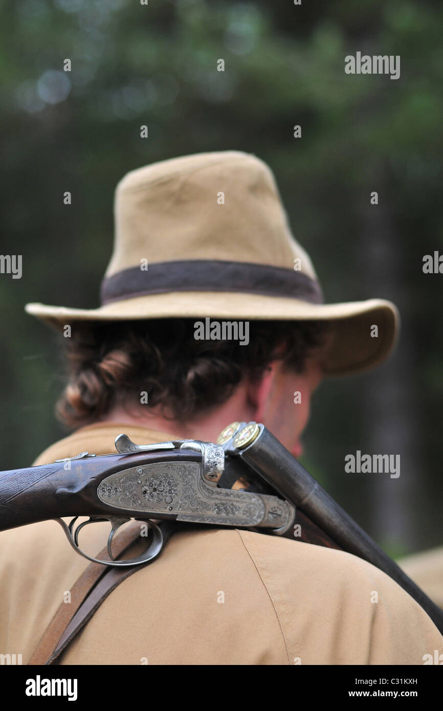 HUNTER WITH HIS FOLDING STOCK RIFLE SLUNG OVER HIS SHOULDER, PRIVATE ...