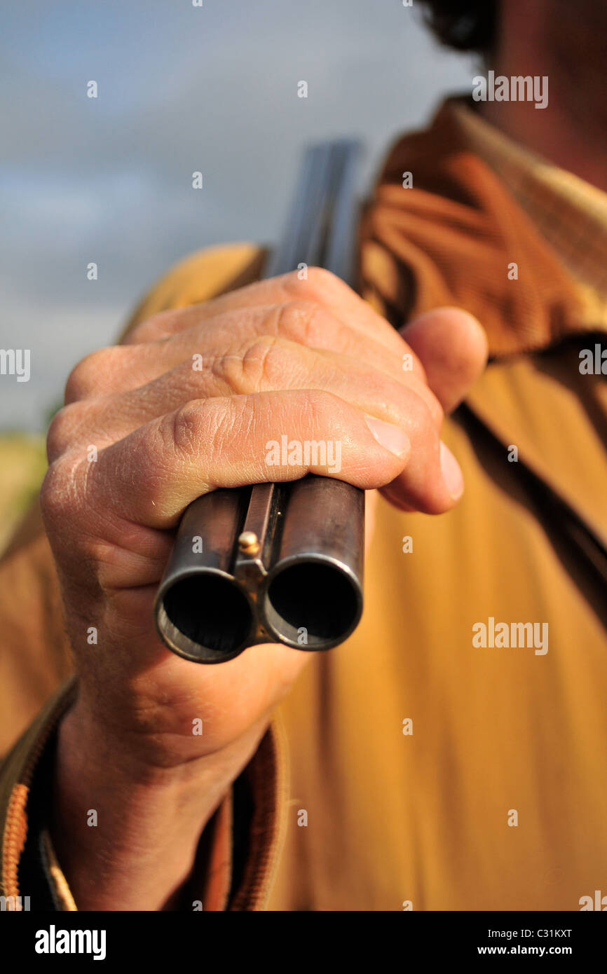 HUNTER CARRYING HIS FOLDING STOCK RIFLE OVER HIS SHOULDER Stock Photo ...