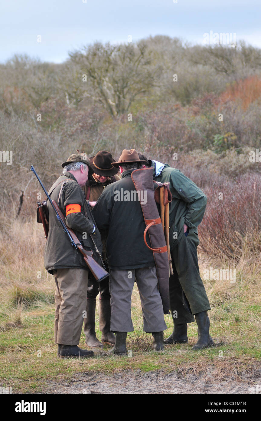 A GROUP OF HUNTERS, HUNTING IN THE NATURE RESERVE OF THE BAY OF SOMME ...