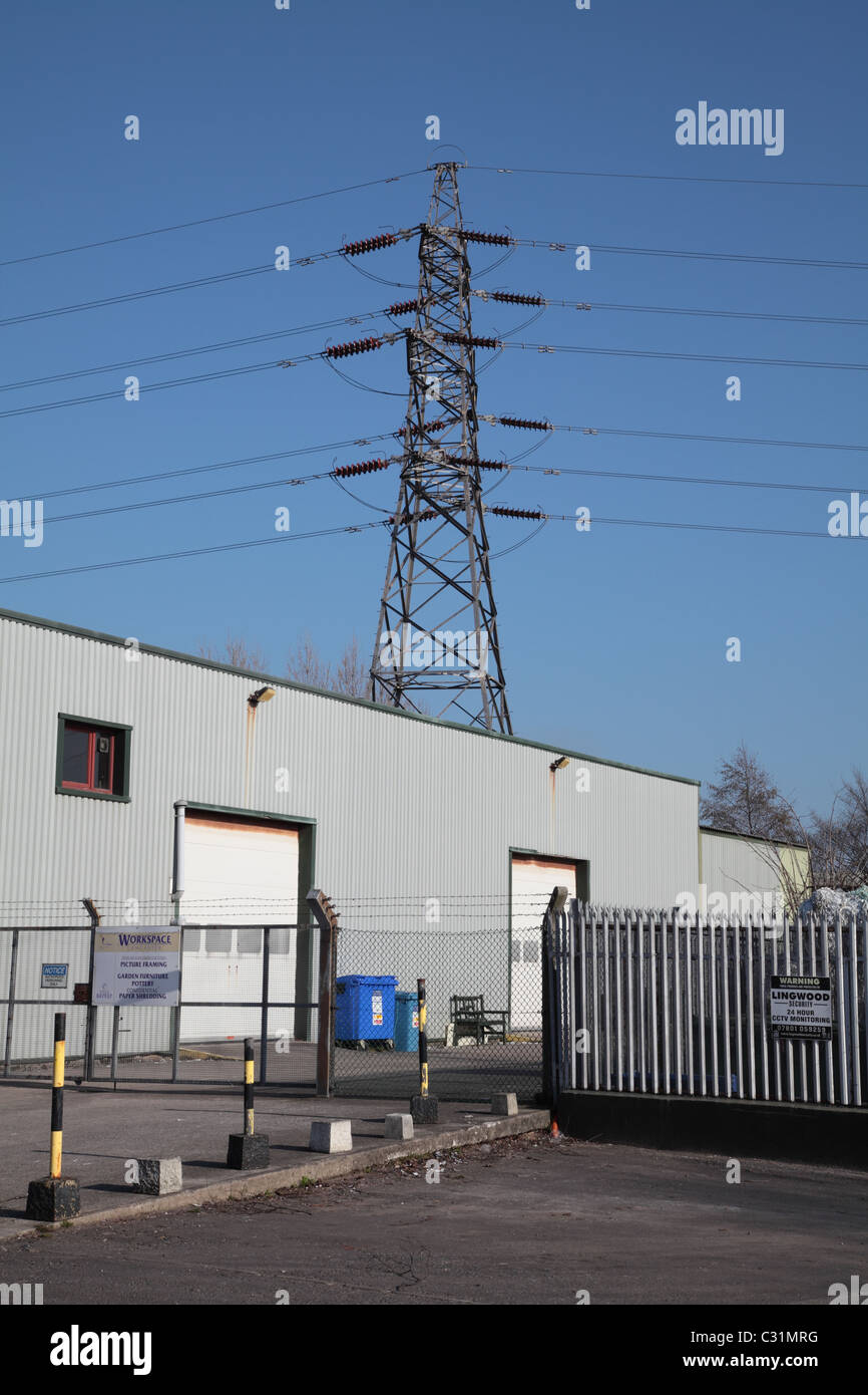 electricity pylon next to industrial unit Stock Photo - Alamy