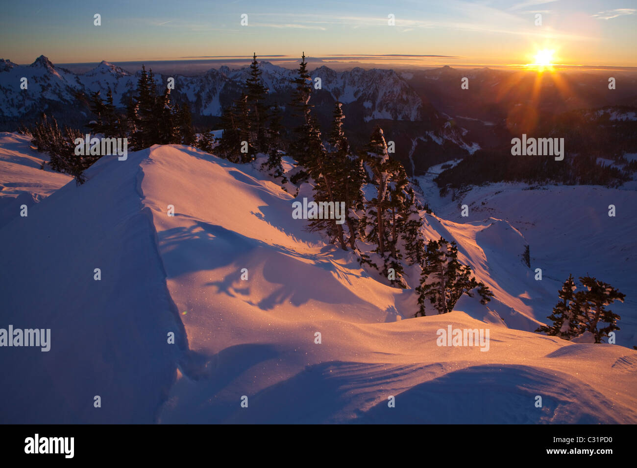 A setting sun illuminates a windswept ridge above Paradise in Mount ...