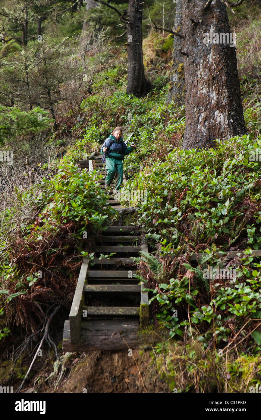A hiker walks down the wooden steps leading down to Third Beach ...