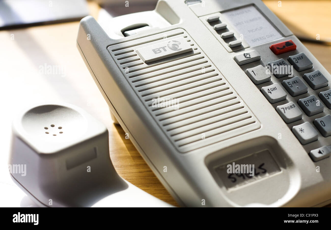 An office phone off the hook- focus is on the main telephone body Stock ...
