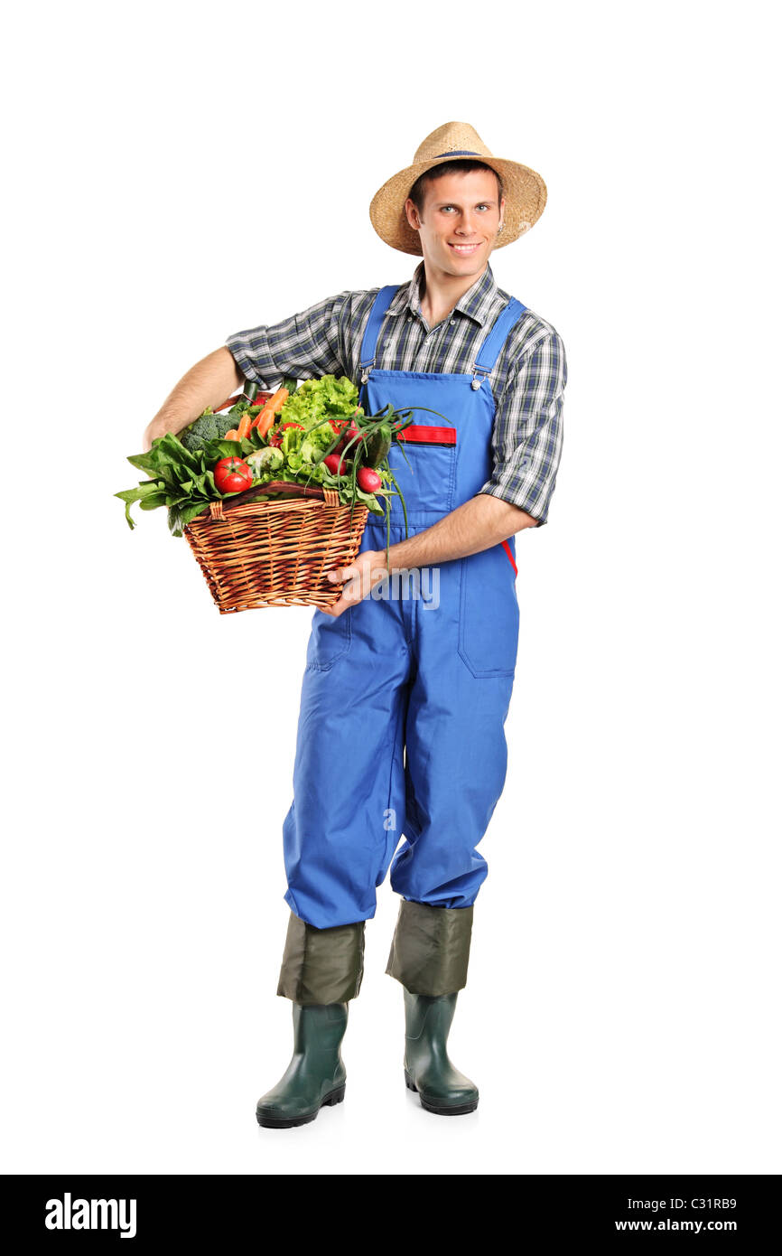 Full length portrait of a farmer holding a basket full of vegetables ...