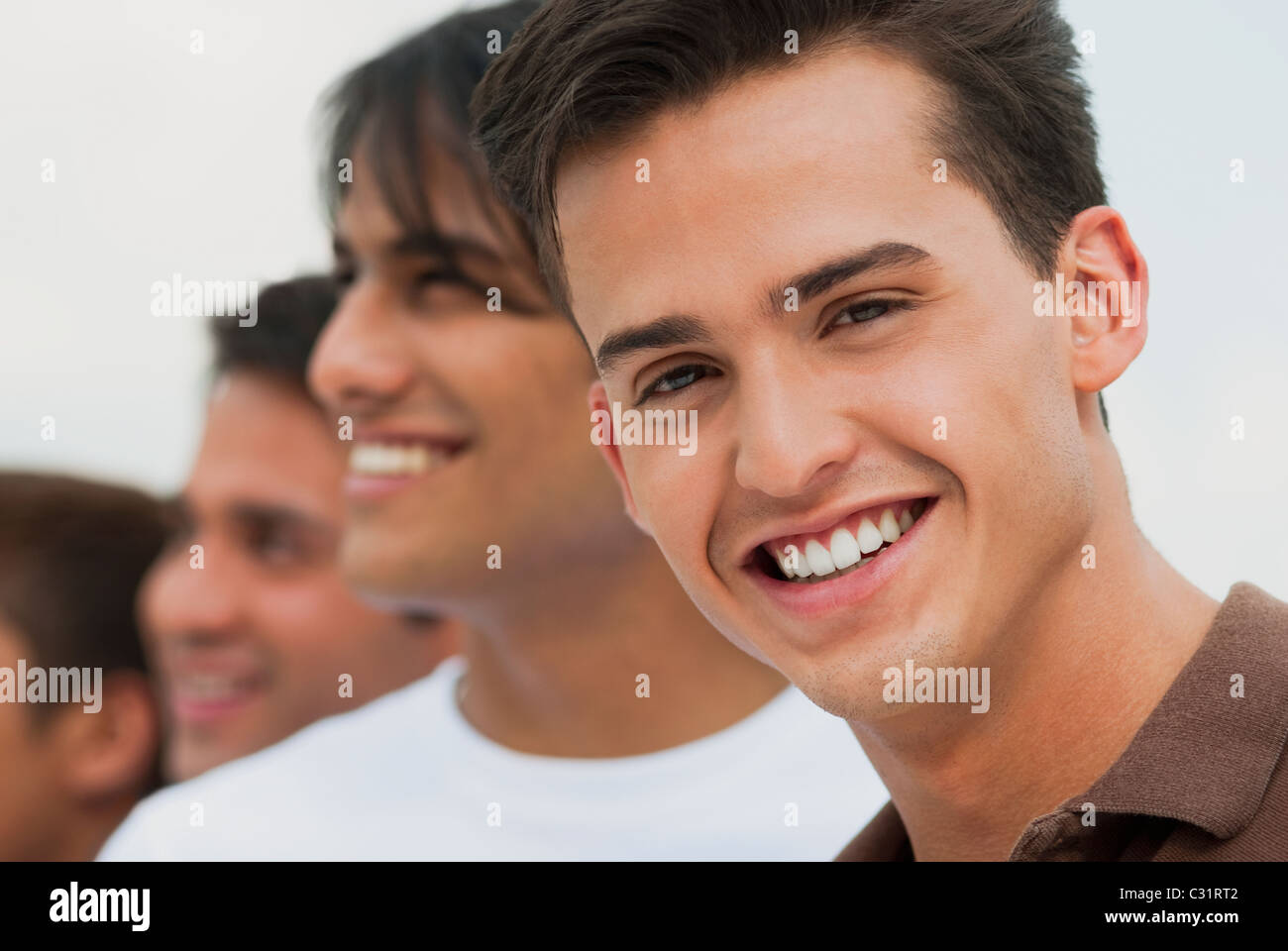 Friends standing a row Stock Photo - Alamy
