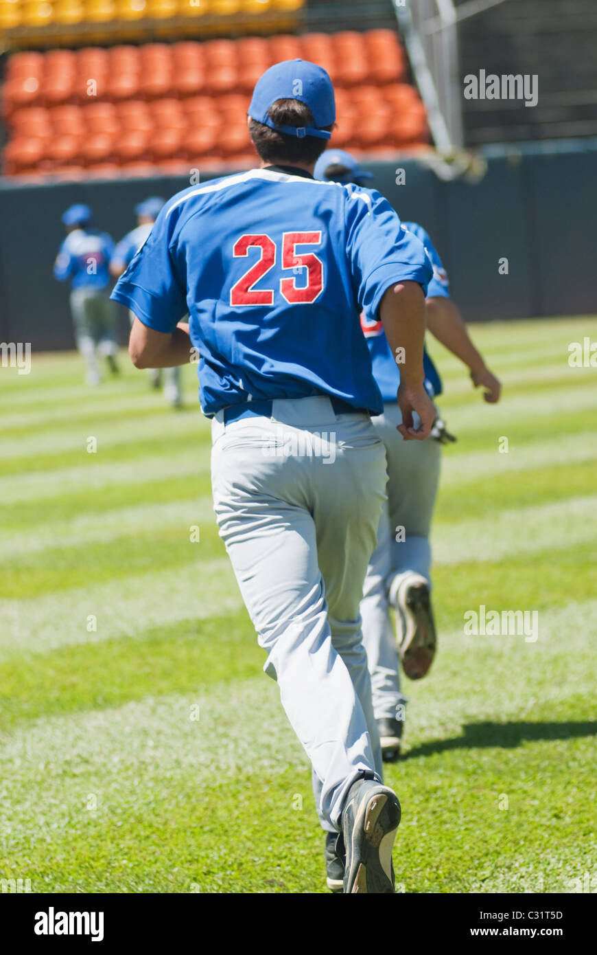 Hispanic baseball player running on field Stock Photo - Alamy