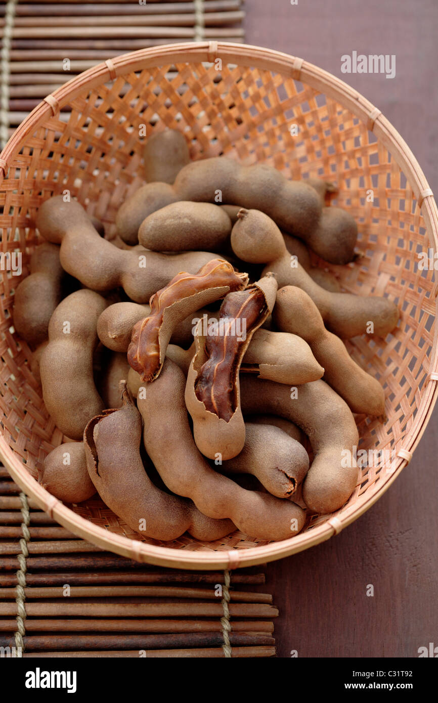 Tamarind pods in wicker basket Stock Photo - Alamy