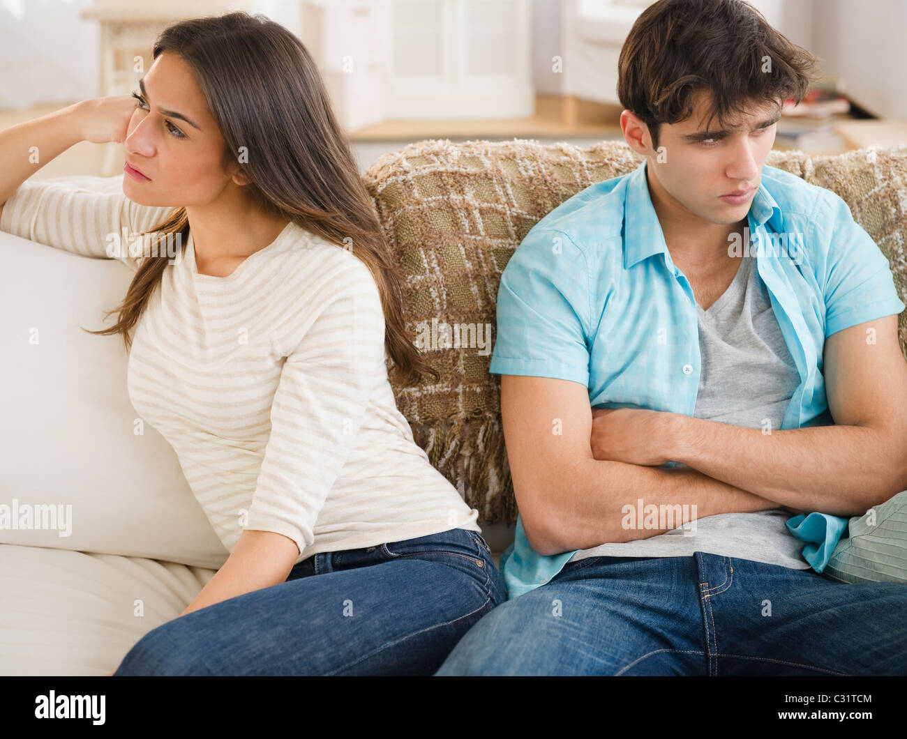 Angry couple sitting on sofa together Stock Photo - Alamy