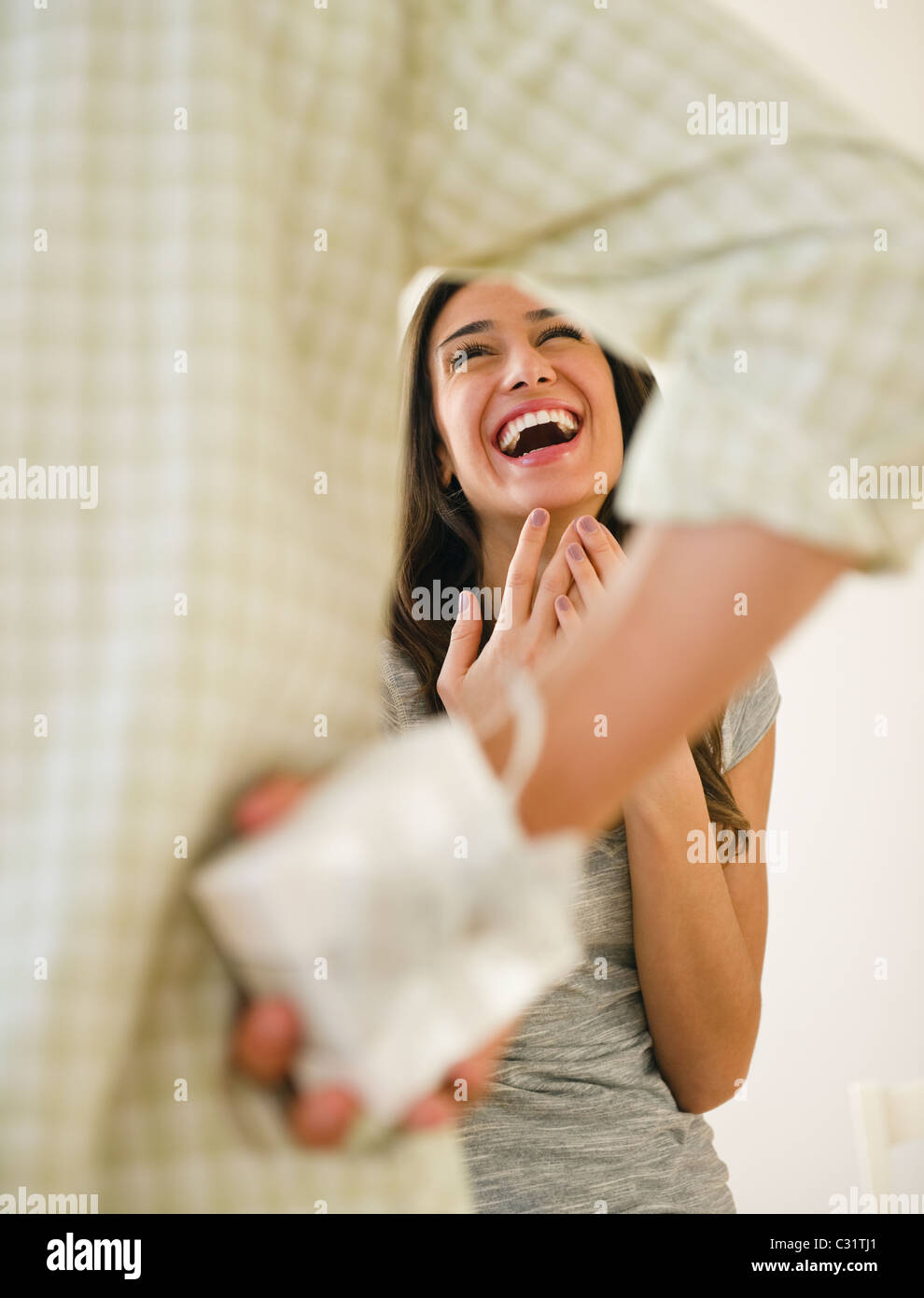 Husband giving gift to laughing wife Stock Photo - Alamy