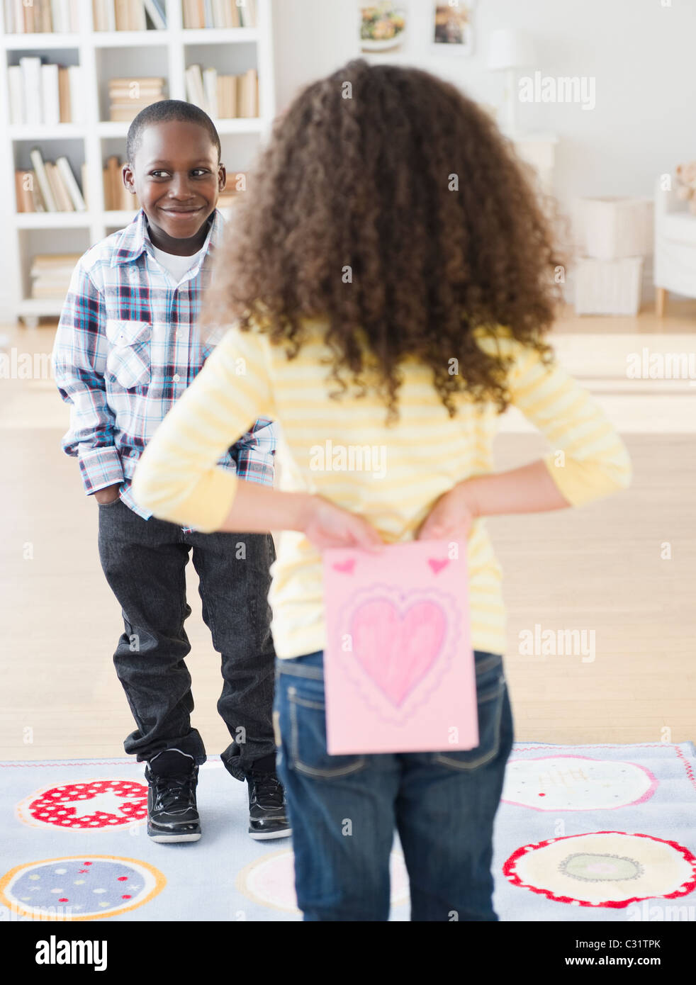 Girl holding Valentine card behind her back Stock Photo - Alamy