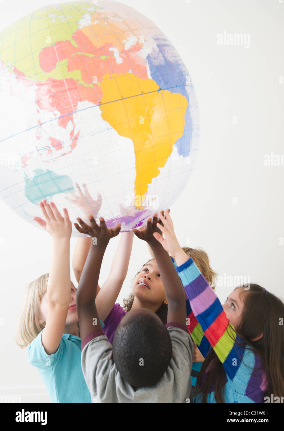Children lifting up plastic globe Stock Photo - Alamy