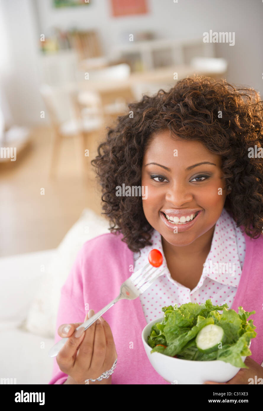 African American woman eating salad Stock Photo - Alamy
