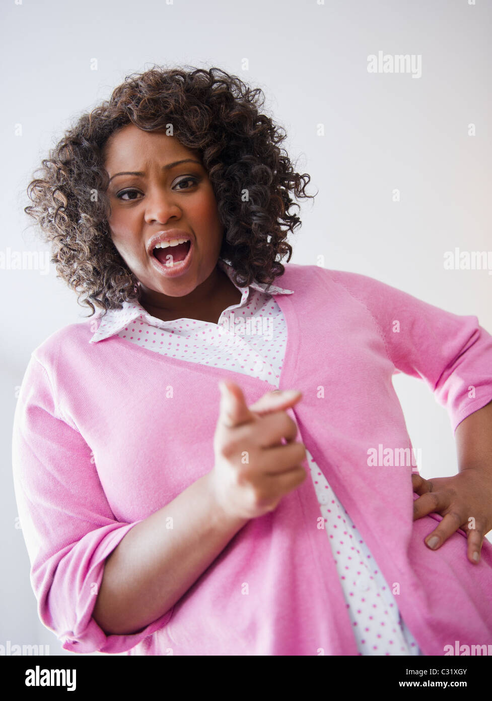 African American woman screaming and pointing her finger Stock Photo ...